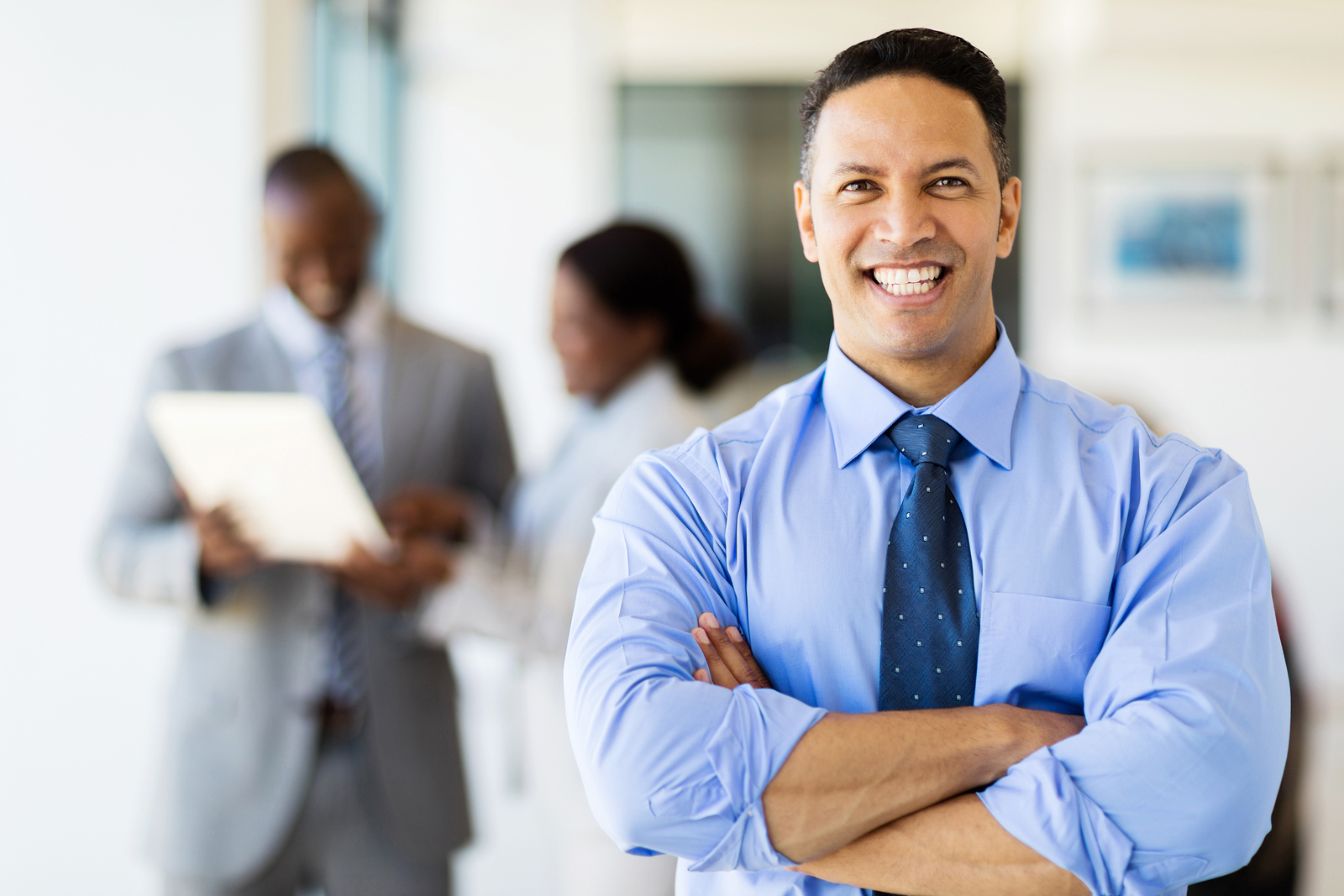 good looking corporate worker in modern office with colleagues o ...